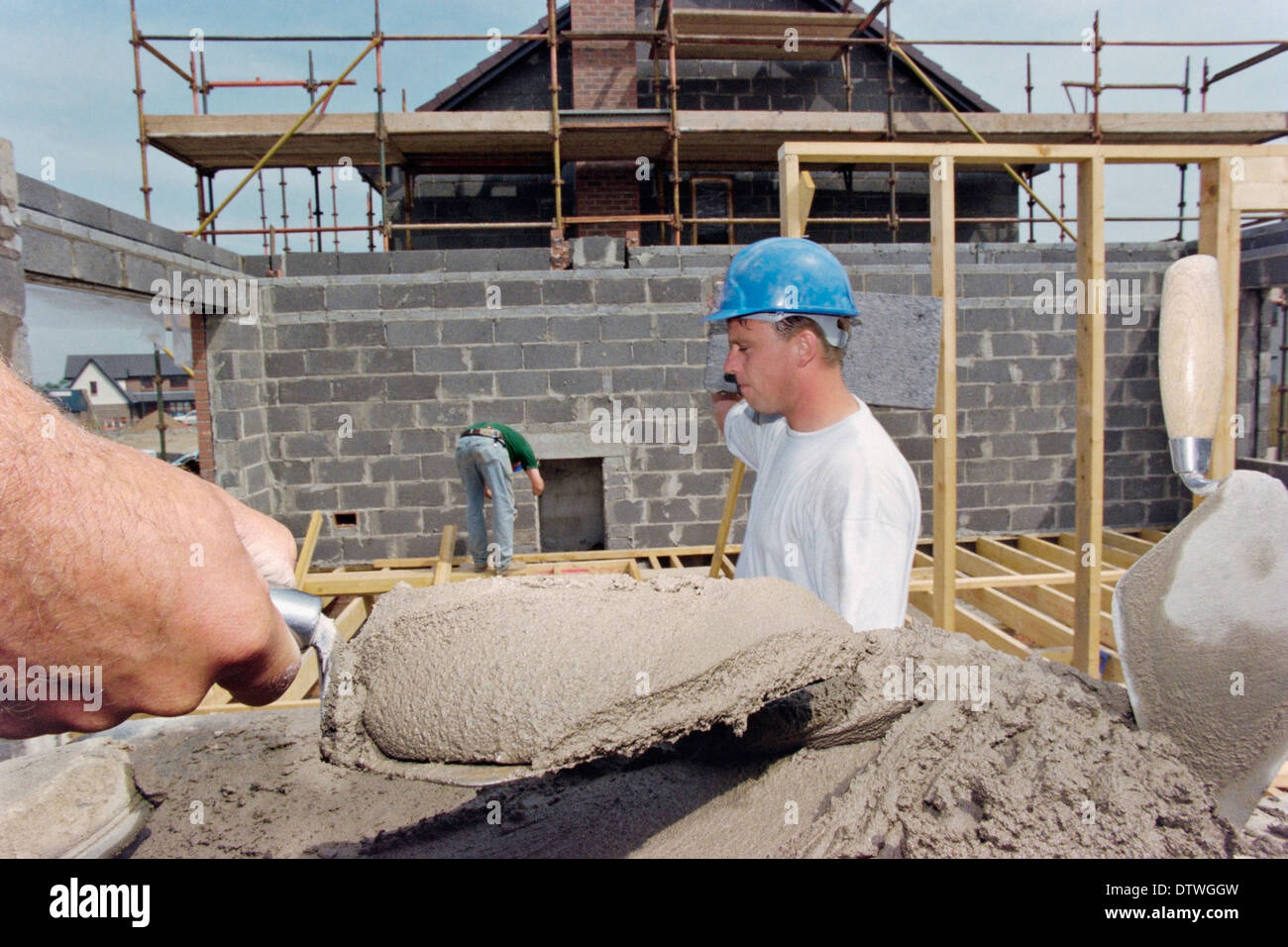 Bricklayers work on the construction of a new house Stock Photo - Alamy