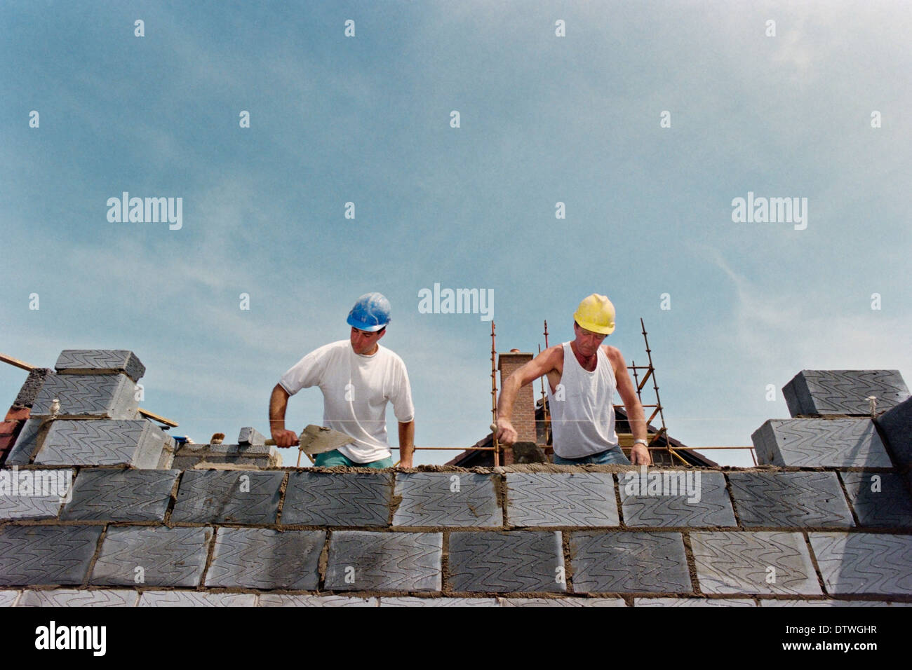 Bricklayers work on the construction of a new house Stock Photo - Alamy