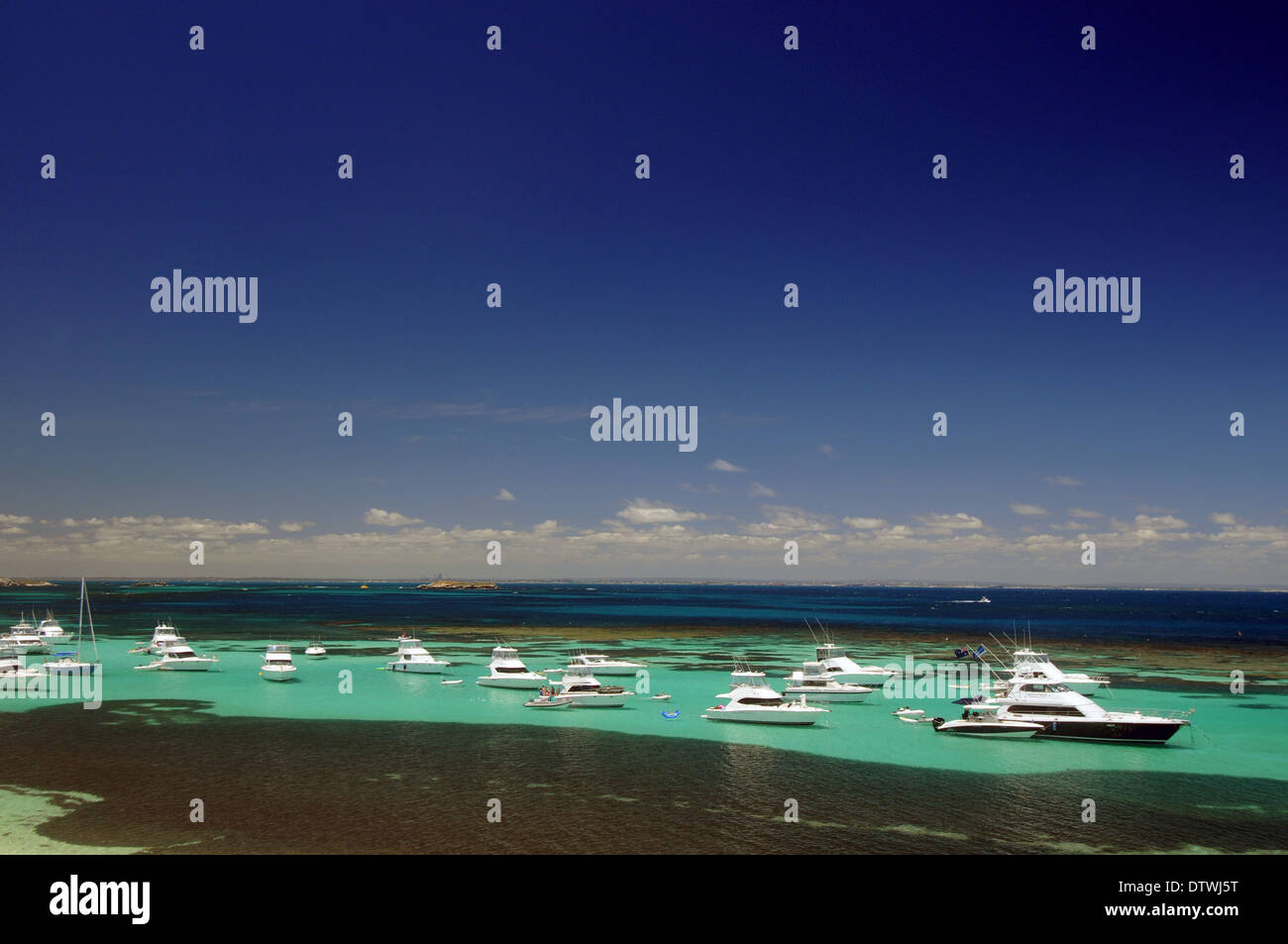 Boats moored at Parker Point, Rottnest Island, with the skyline of ...