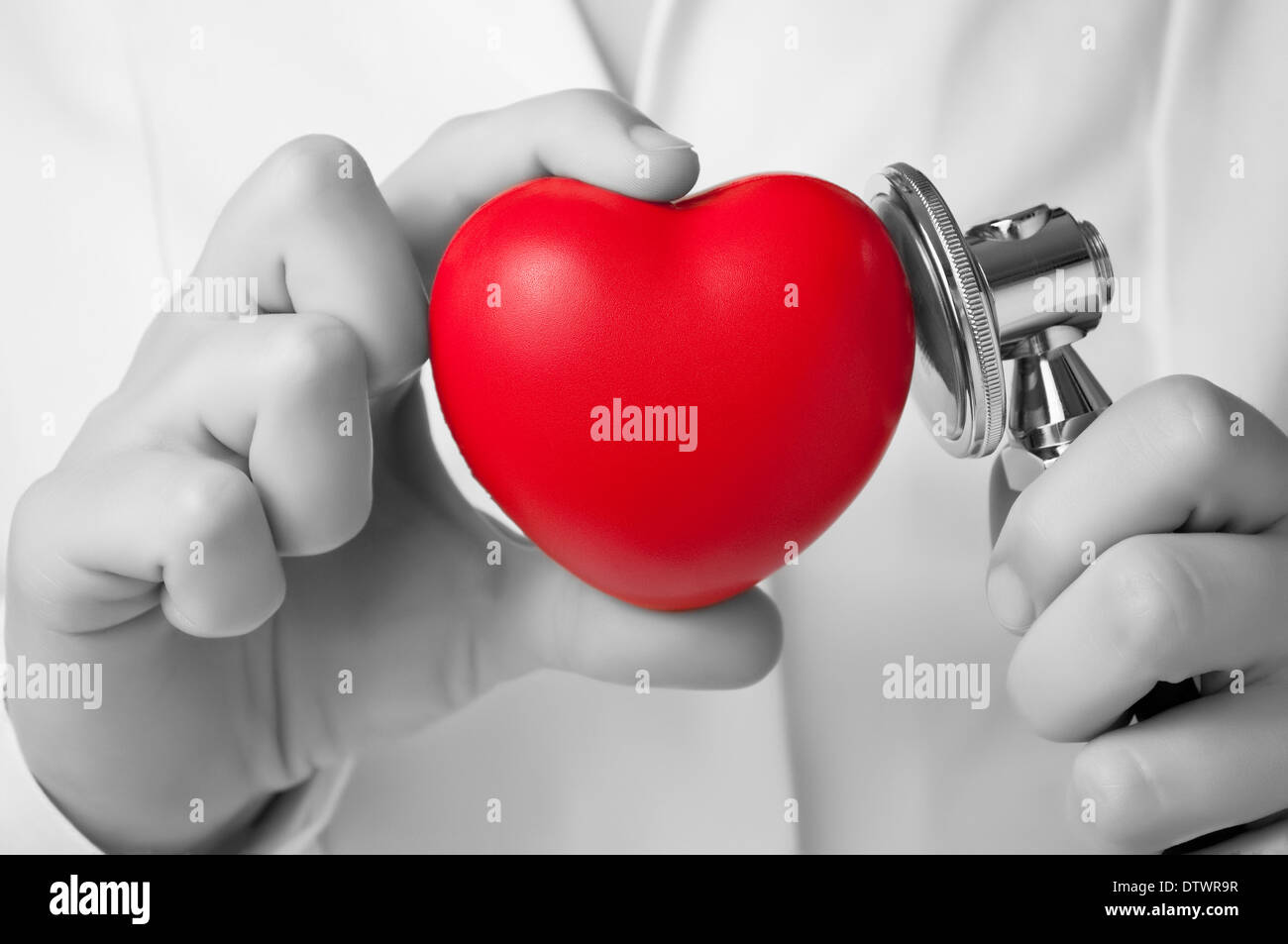 A doctor with stethoscope examining heart hi-res stock photography and ...