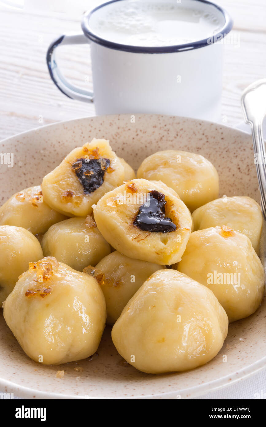 Potato dumplings with plums full Stock Photo - Alamy