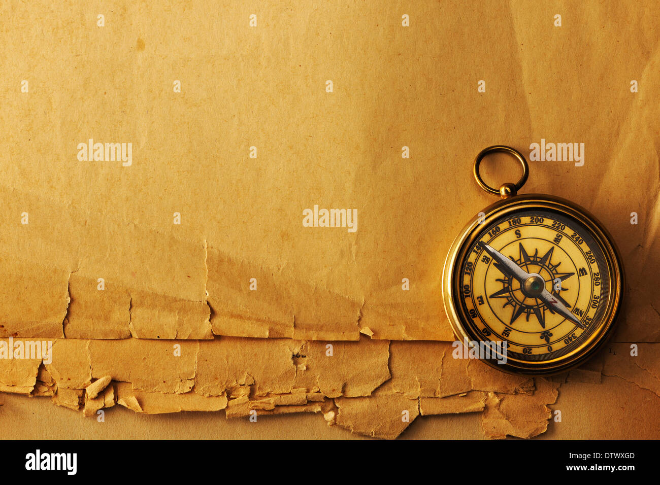 Antique brass compass over old background Stock Photo - Alamy