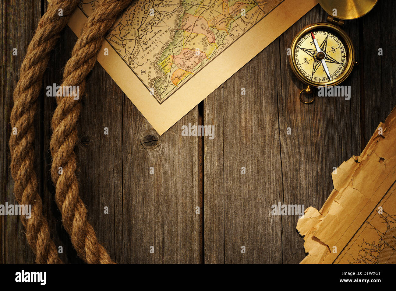 Antique compass and rope over old map Stock Photo - Alamy
