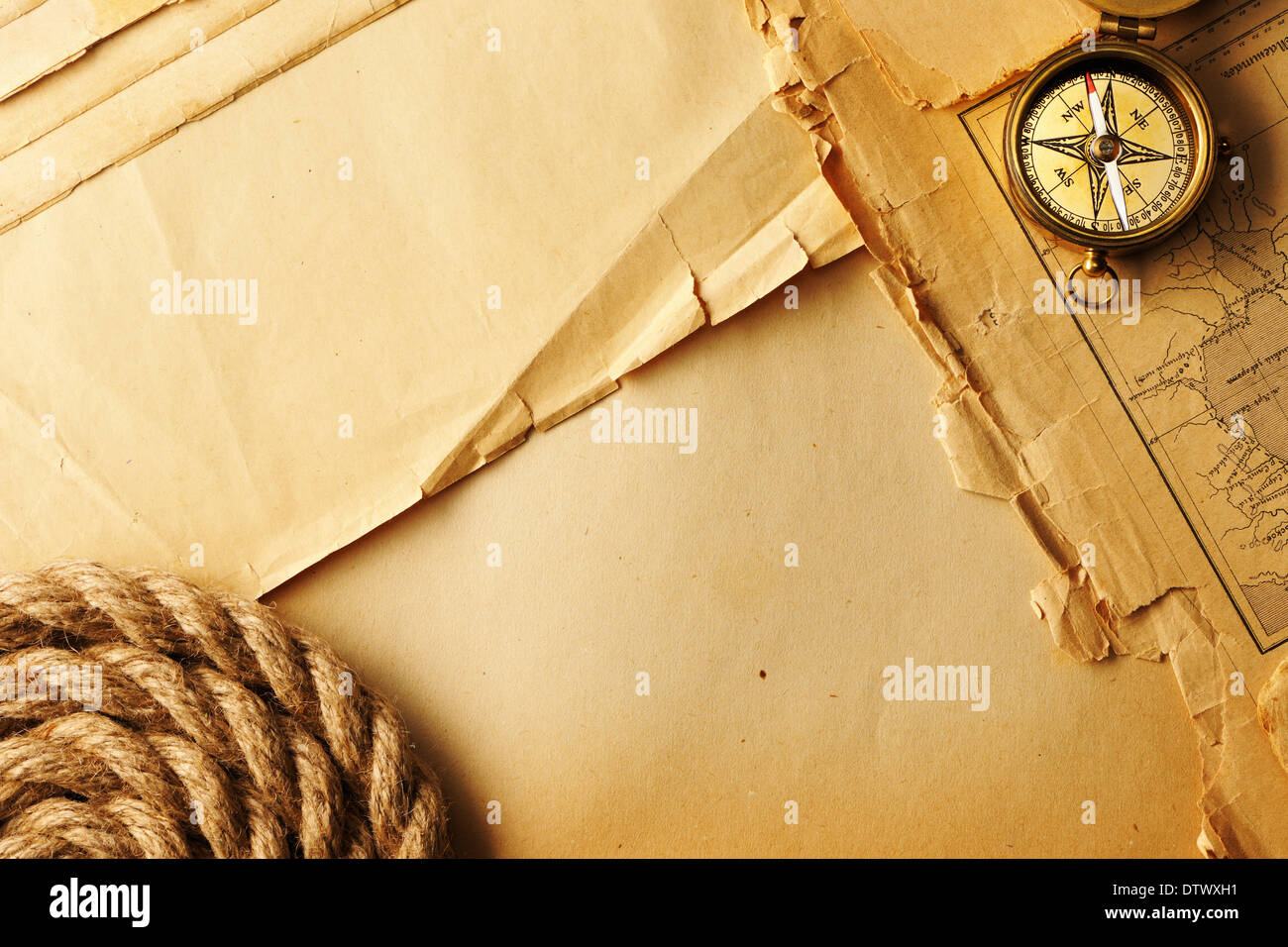 Antique compass and rope over old map Stock Photo - Alamy