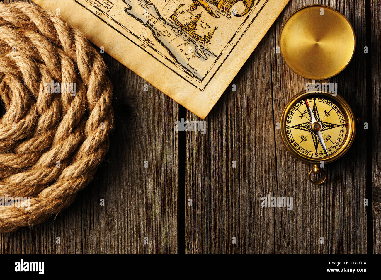 Antique compass and rope over old map Stock Photo - Alamy