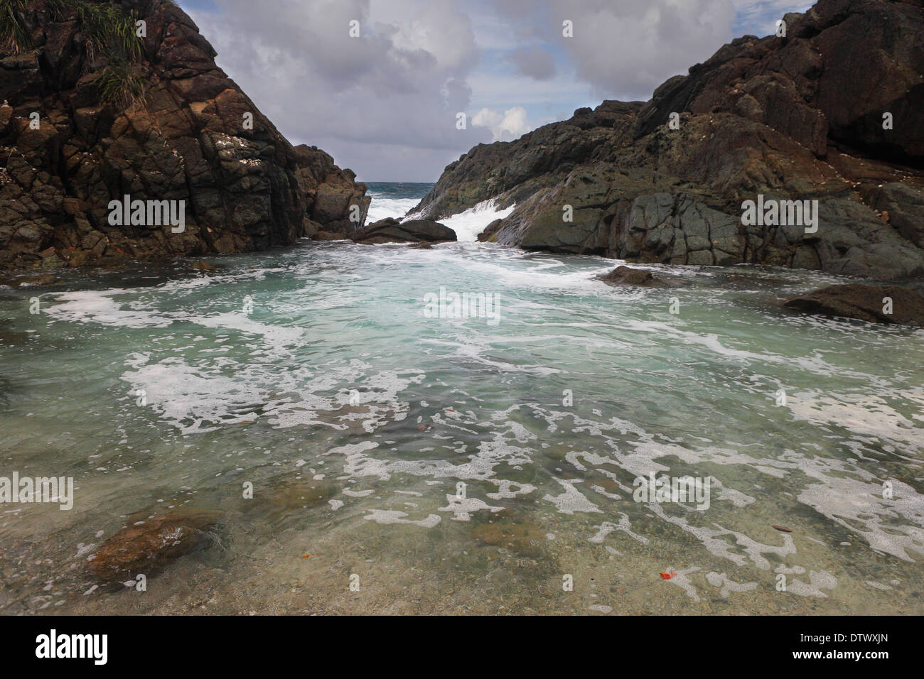 The Caribbean tide is forced in between rocks to create a bubbling pool ...