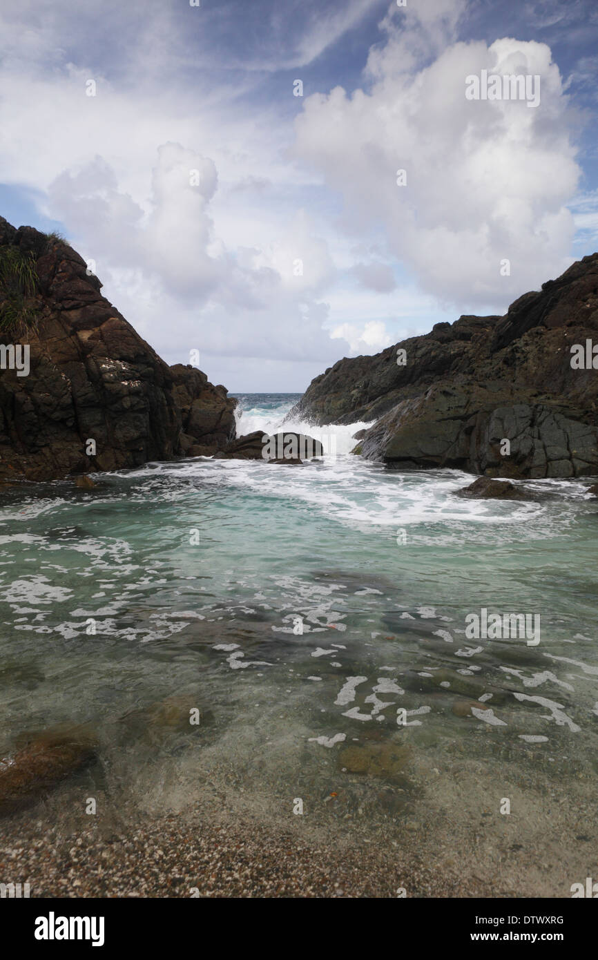 The Caribbean tide is forced in between rocks to create a bubbling pool ...