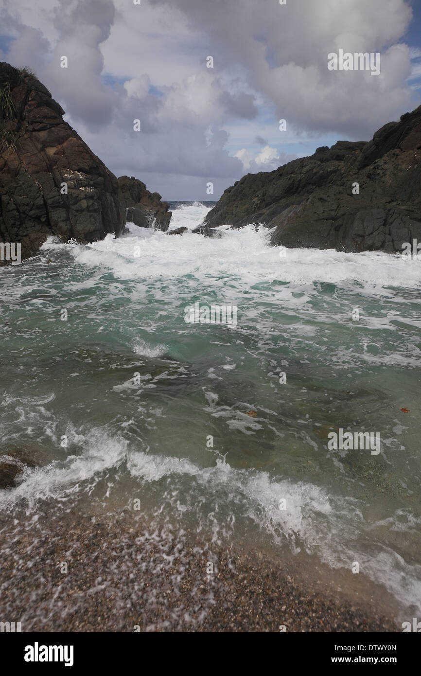 The Caribbean tide is forced in between rocks to create a bubbling pool ...