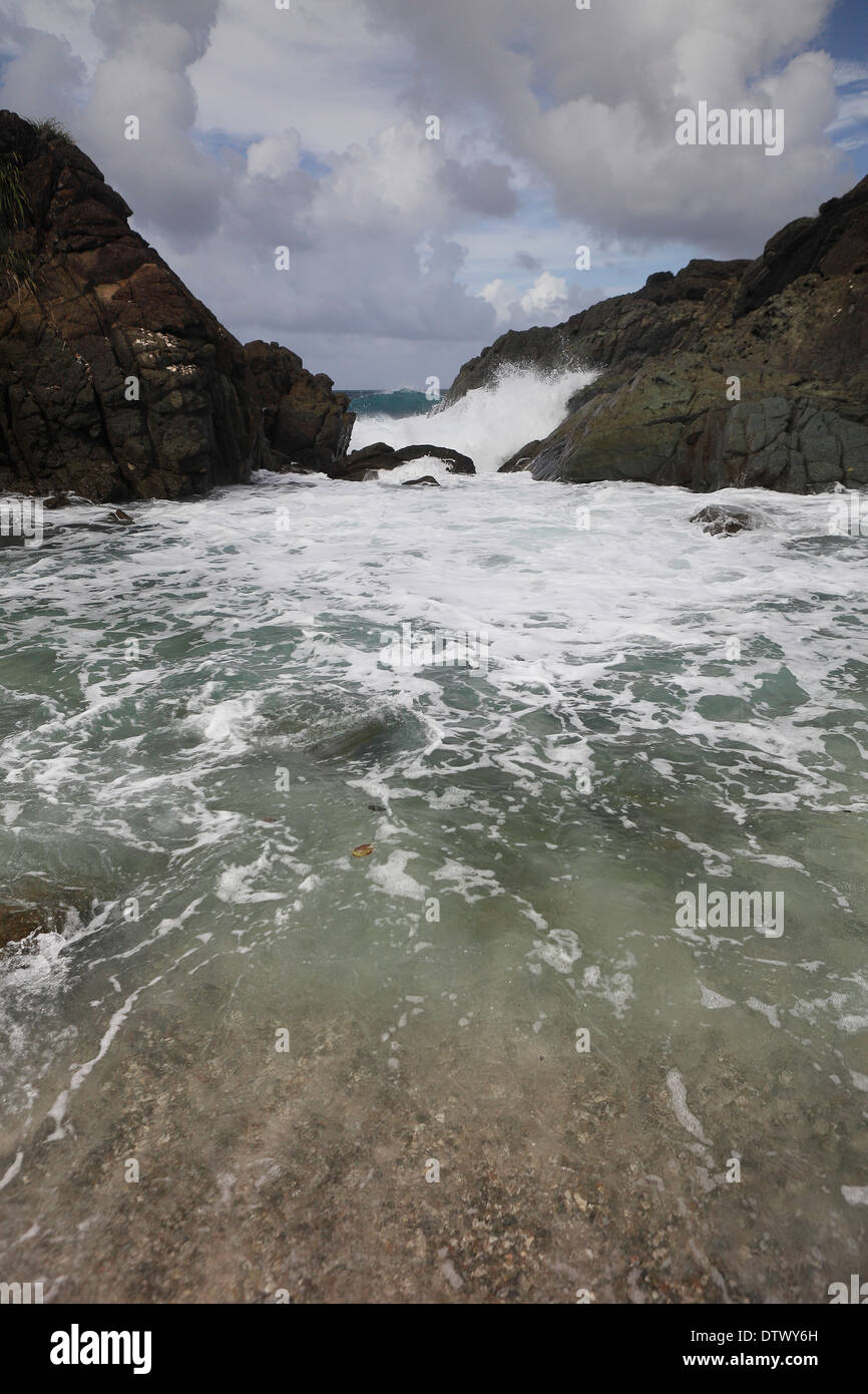 The Caribbean tide is forced in between rocks to create a bubbling pool ...