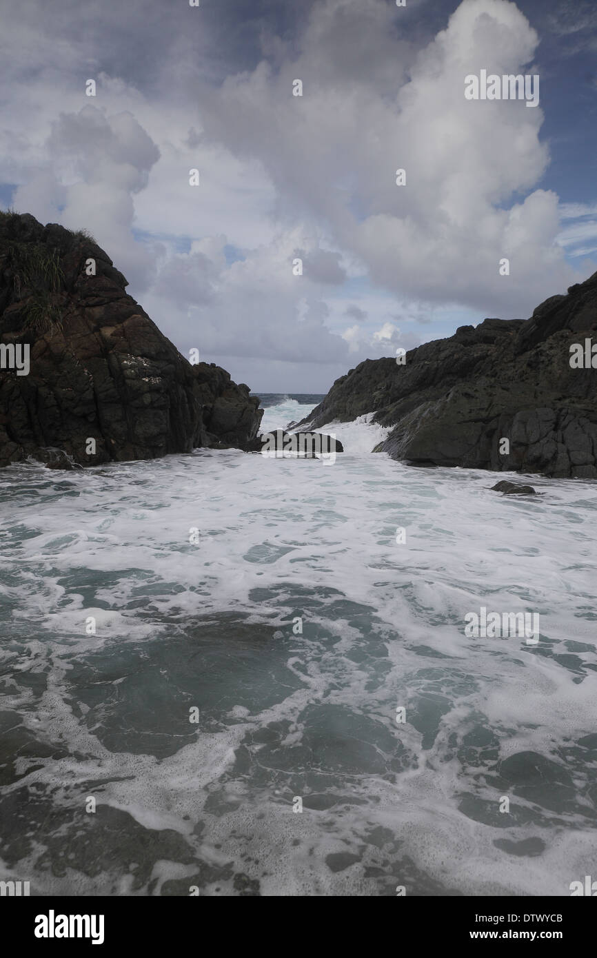 The Caribbean tide is forced in between rocks to create a bubbling pool ...