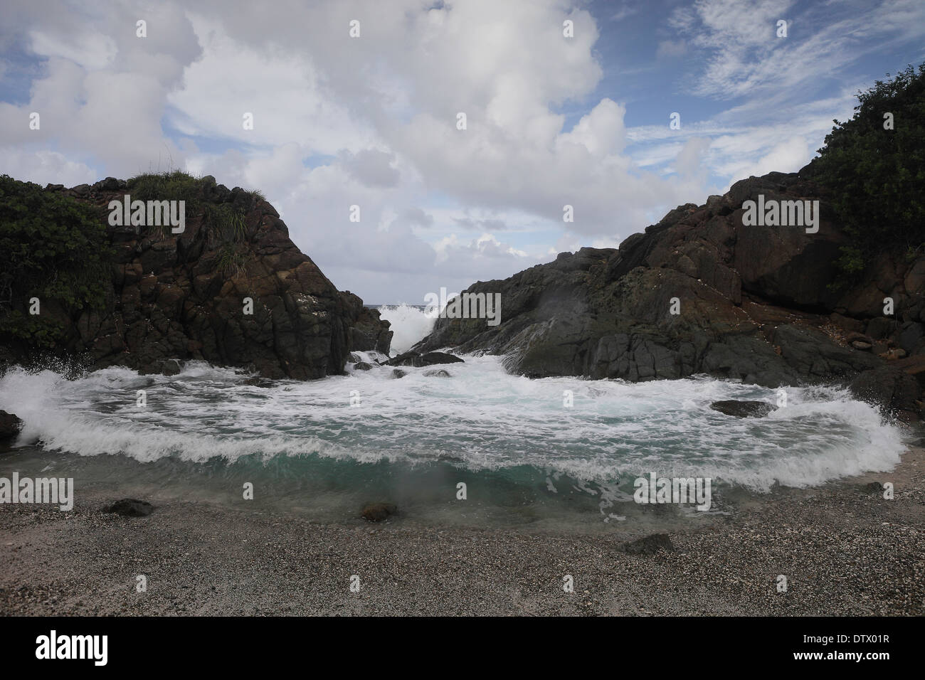 The Caribbean tide is forced in between rocks to create a bubbling pool ...