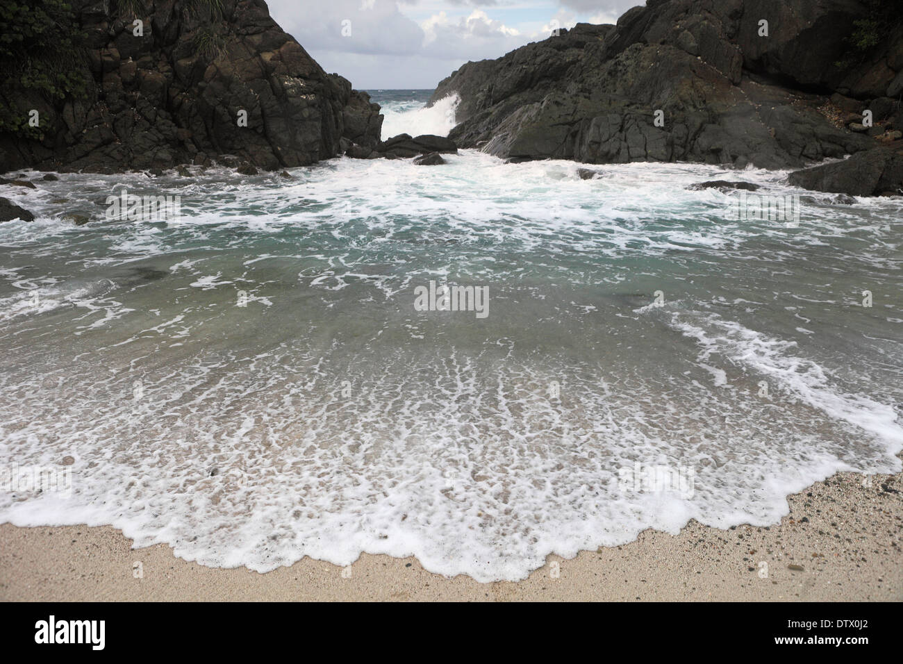 The Caribbean tide is forced in between rocks to create a bubbling pool ...