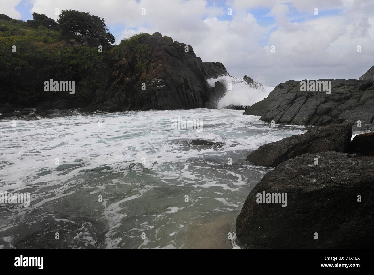 The Caribbean tide is forced in between rocks to create a bubbling pool ...