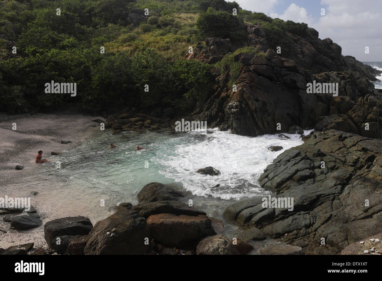 The Caribbean tide is forced in between rocks to create a bubbling pool ...