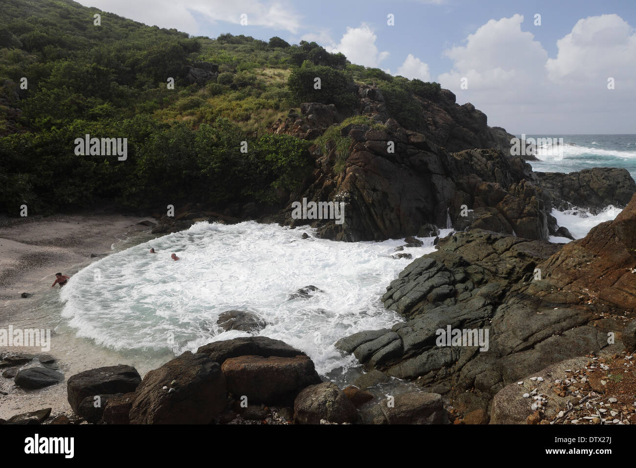 The Caribbean tide is forced in between rocks to create a bubbling pool ...