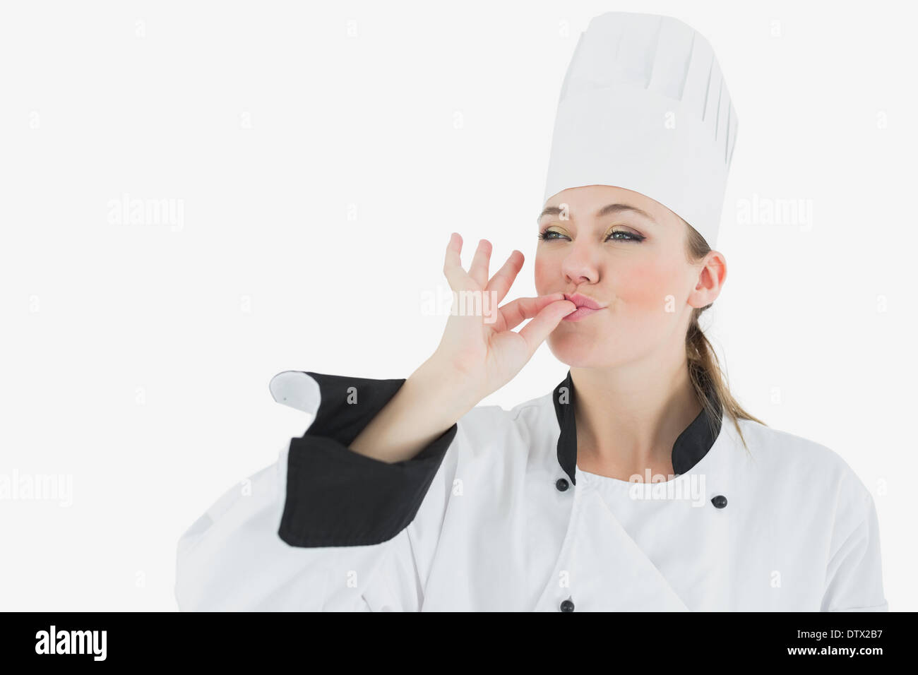 Female chef in uniform blowing a kiss Stock Photo - Alamy