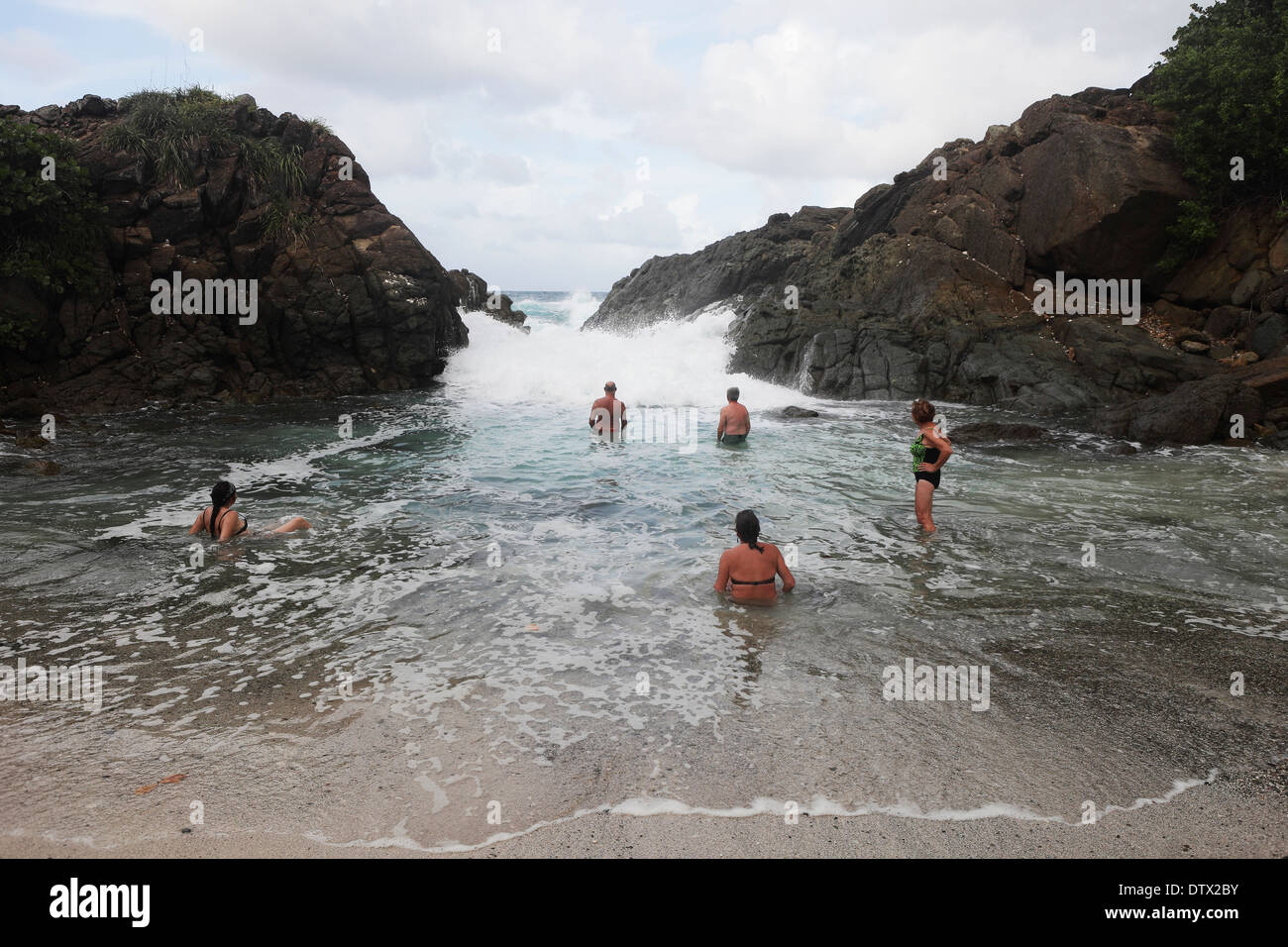 The Caribbean tide is forced in between rocks to create a bubbling pool ...