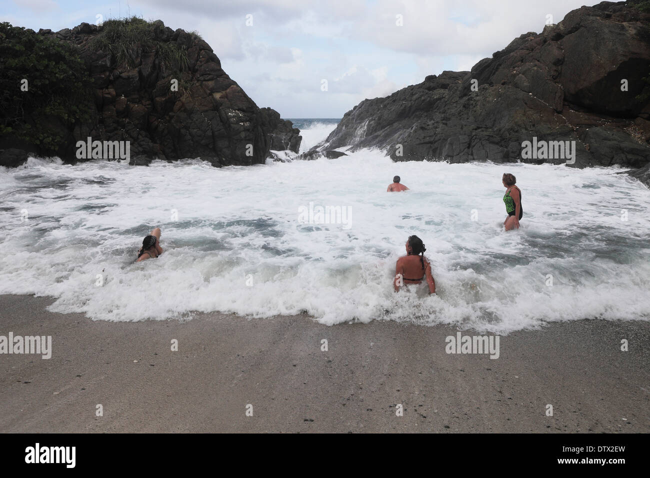 The Caribbean tide is forced in between rocks to create a bubbling pool ...