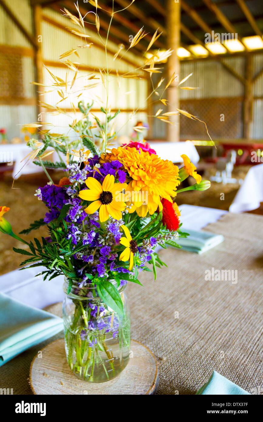 Organic natural wildflowers are placed in mason jars to create the ...