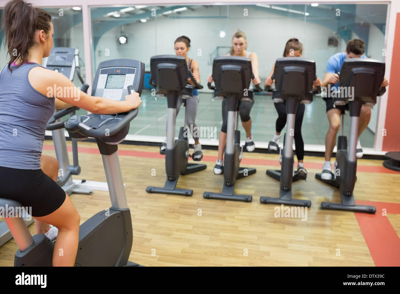Woman teaching spinning class Stock Photo - Alamy