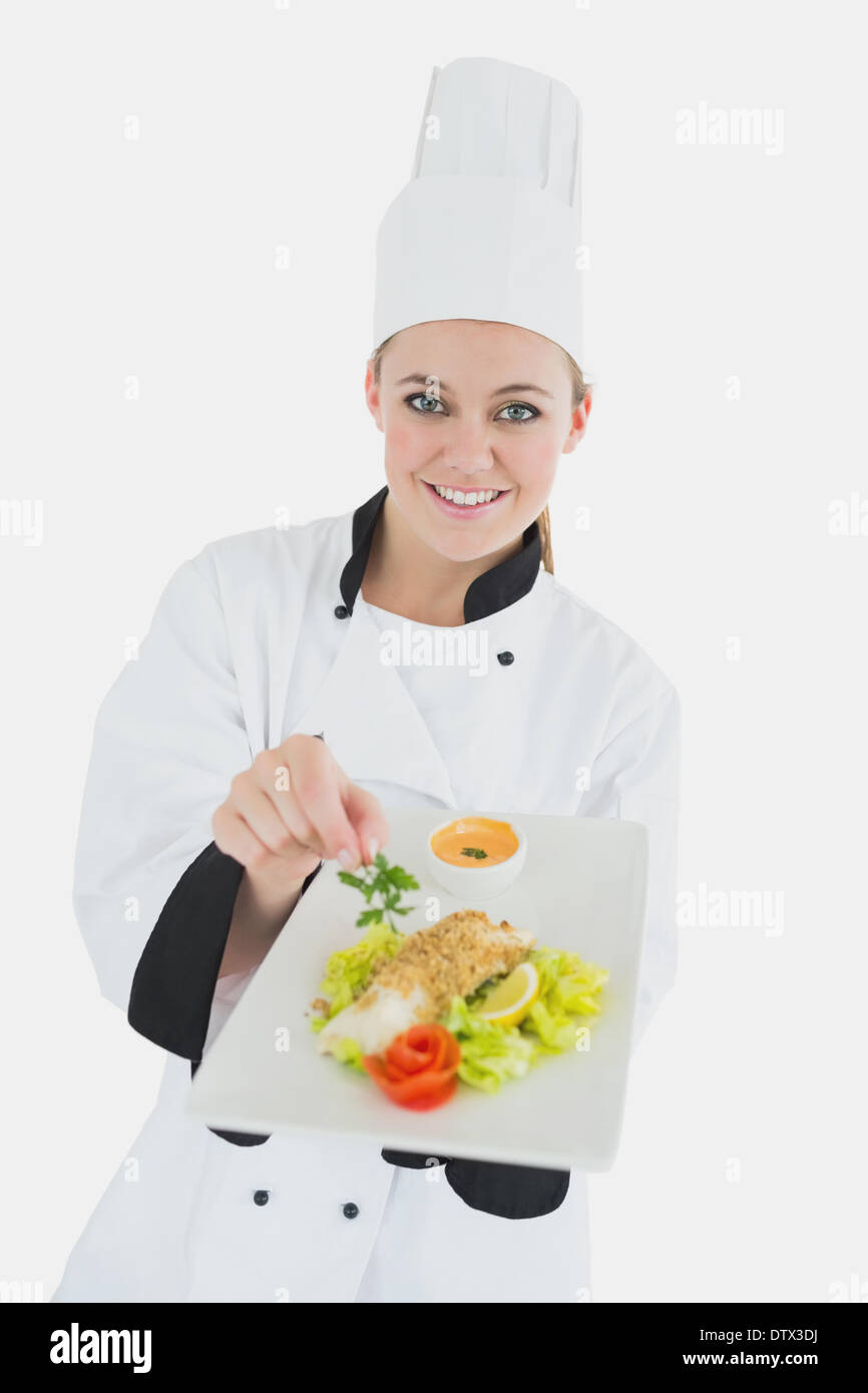 Female chef holding plate of healthy food Stock Photo - Alamy