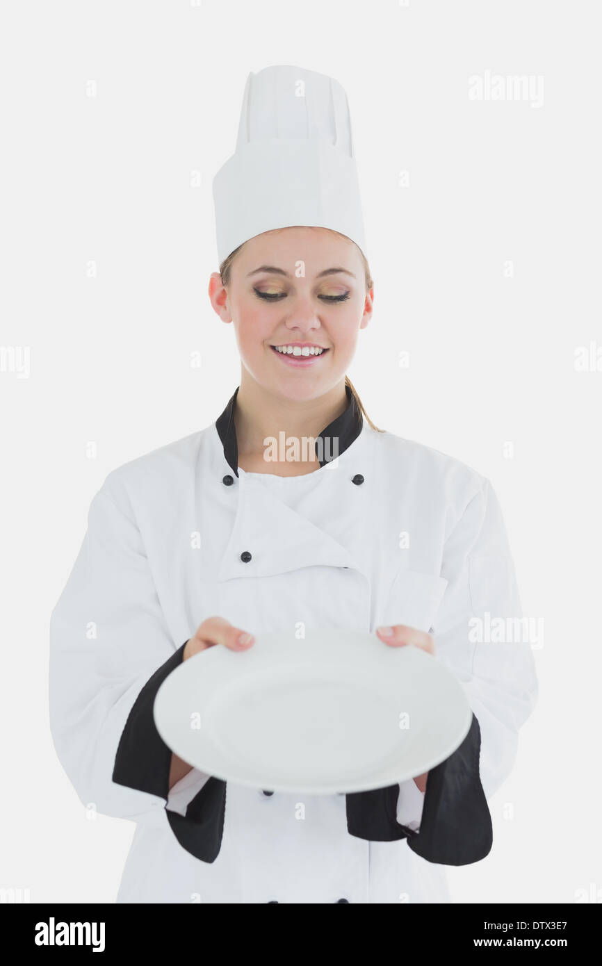 Chef holding an empty plate Stock Photo - Alamy