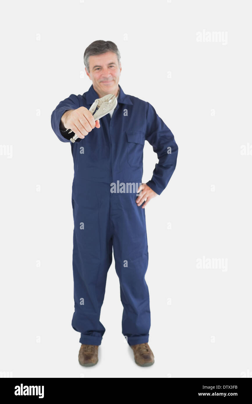 Mechanic holding pliers Stock Photo - Alamy