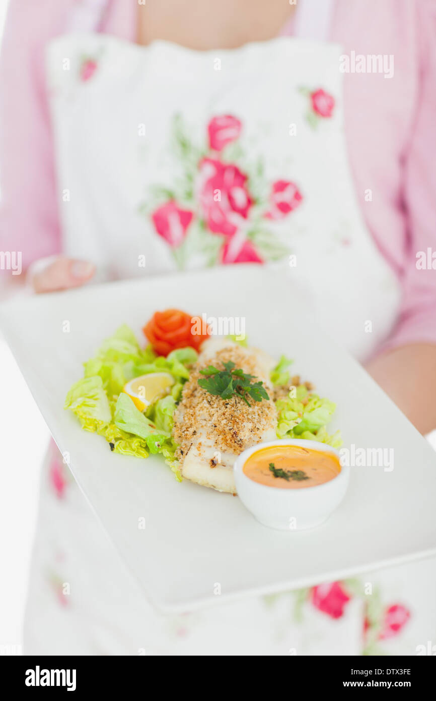 Maid holding plate of healthy food Stock Photo - Alamy