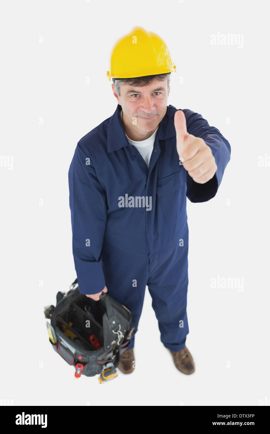 Technician with tool bag gesturing thumbs up Stock Photo - Alamy