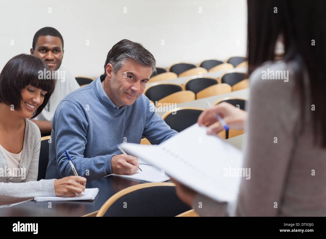 Students smiling in lecture Stock Photo - Alamy