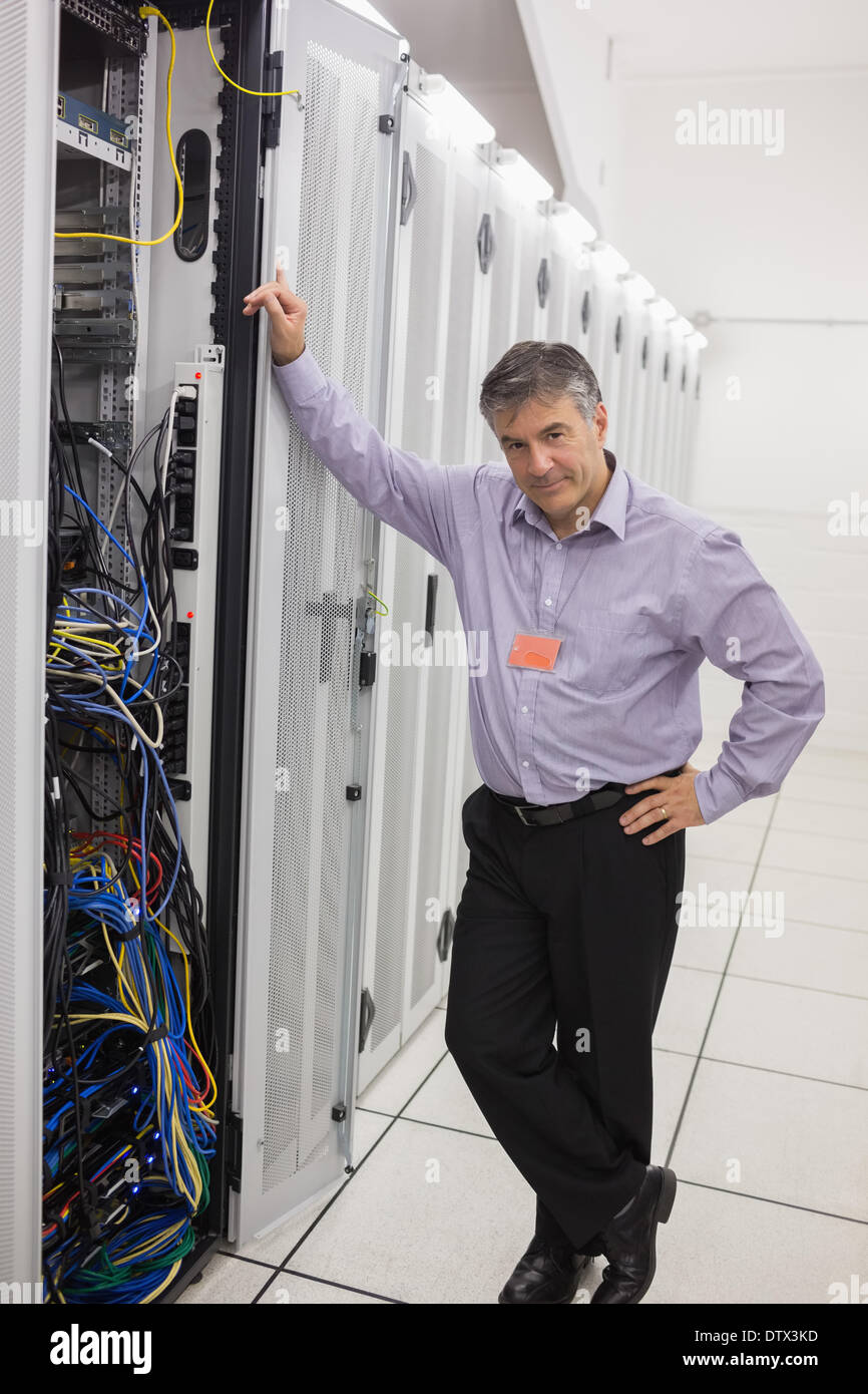 Man standing next to a server tower Stock Photo - Alamy