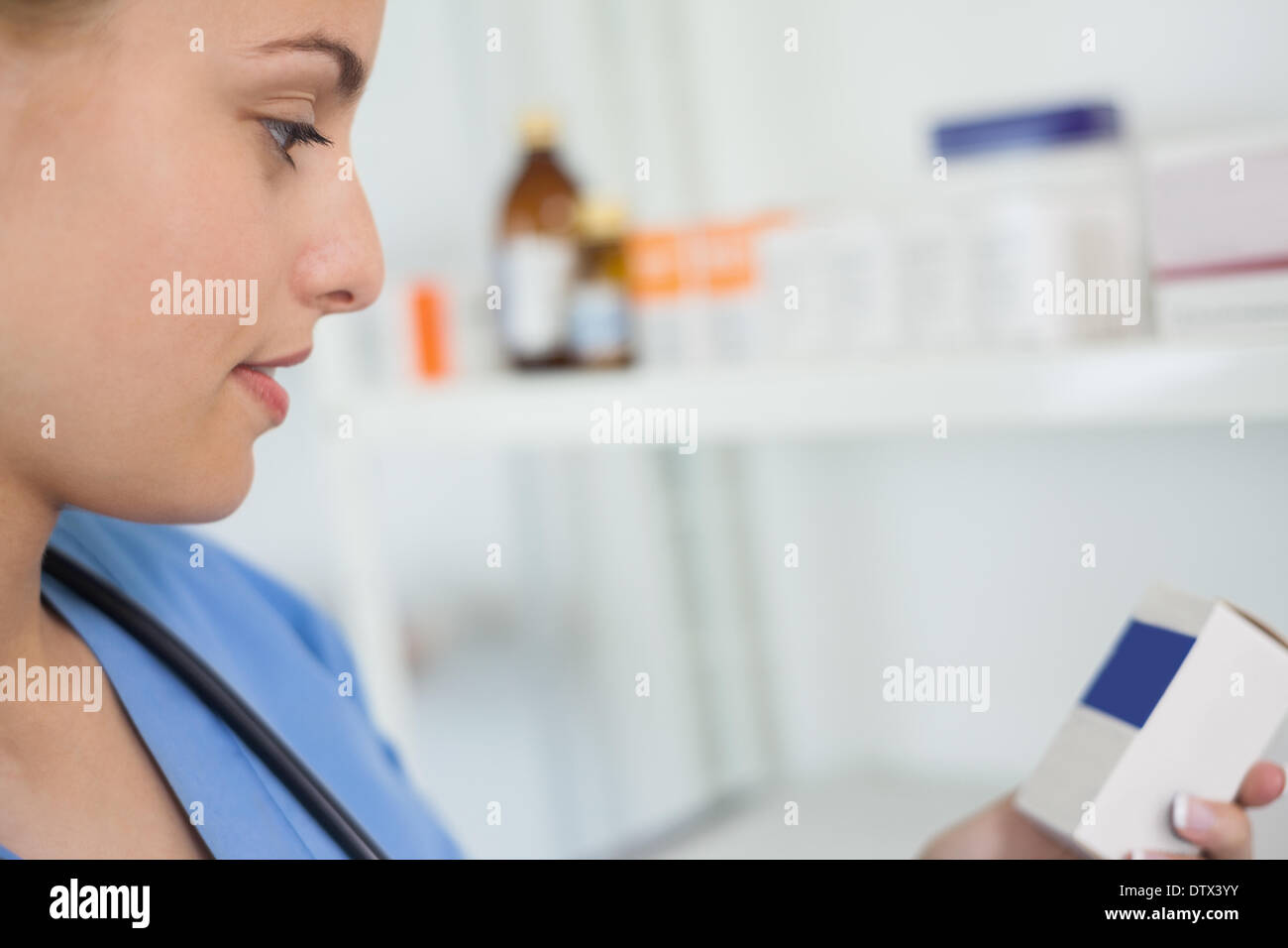 Nurse looking at a medicine box Stock Photo - Alamy