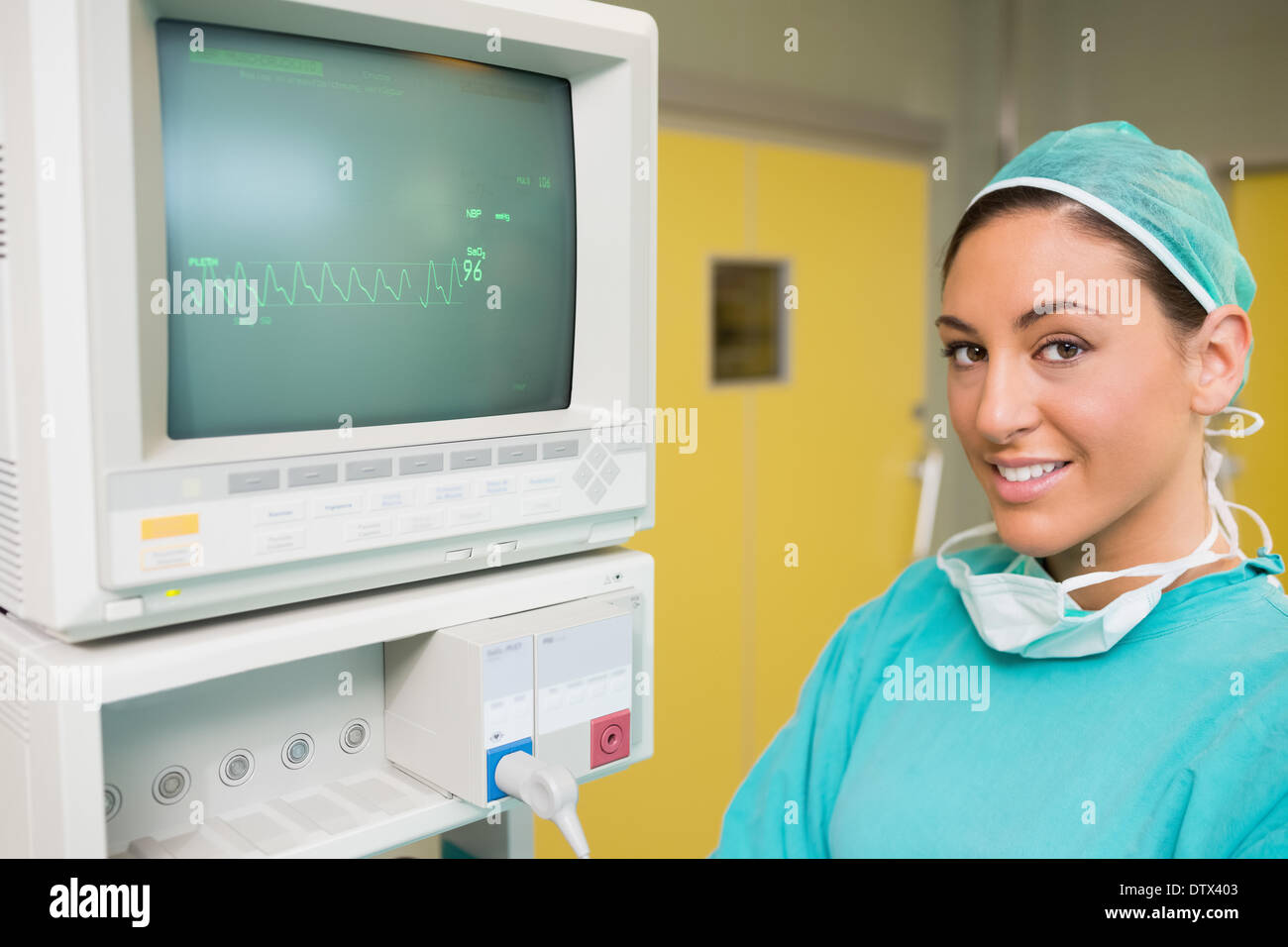 Smiling surgeon standing next to a monitor Stock Photo - Alamy