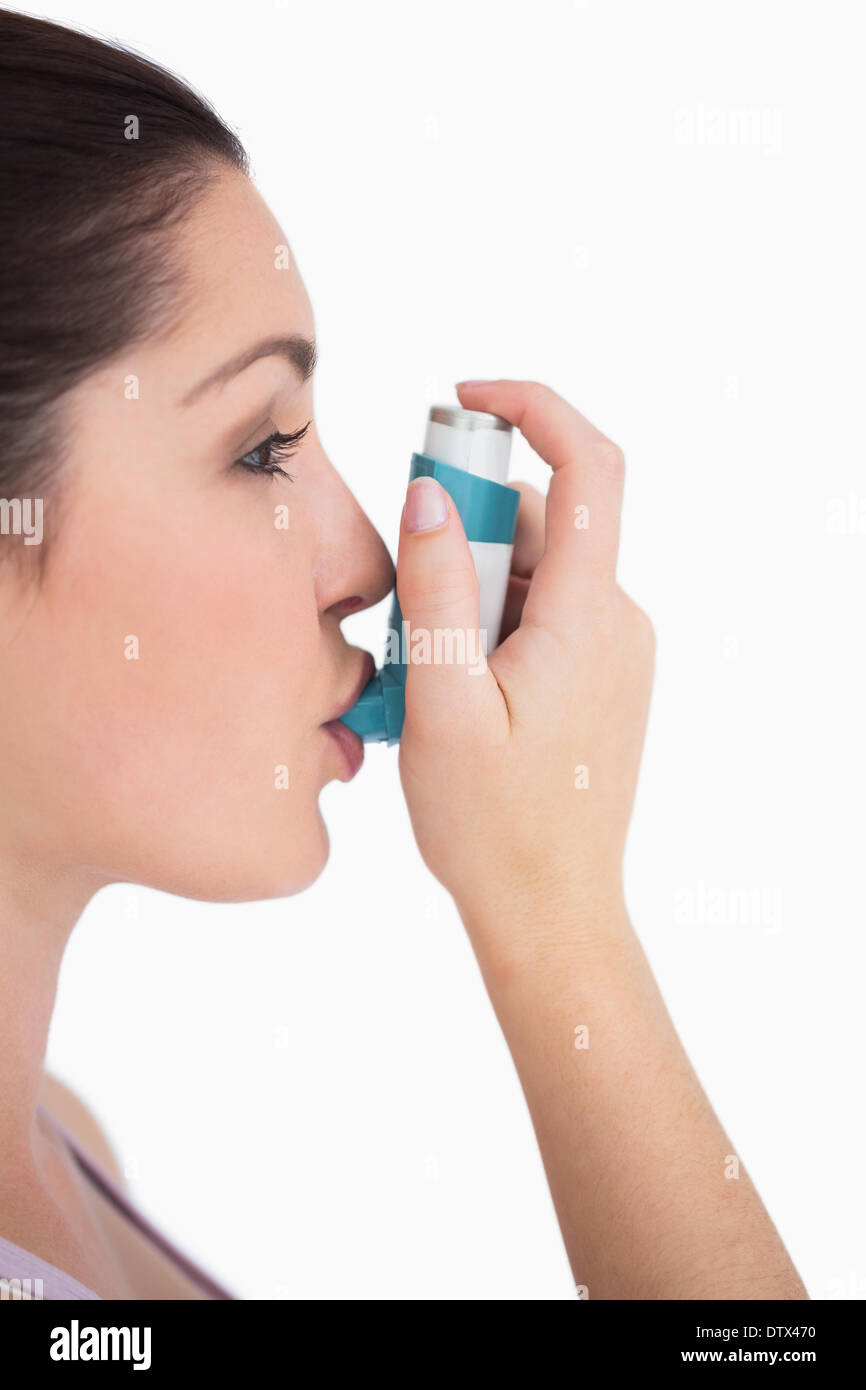 Woman using asthma inhaler Stock Photo - Alamy