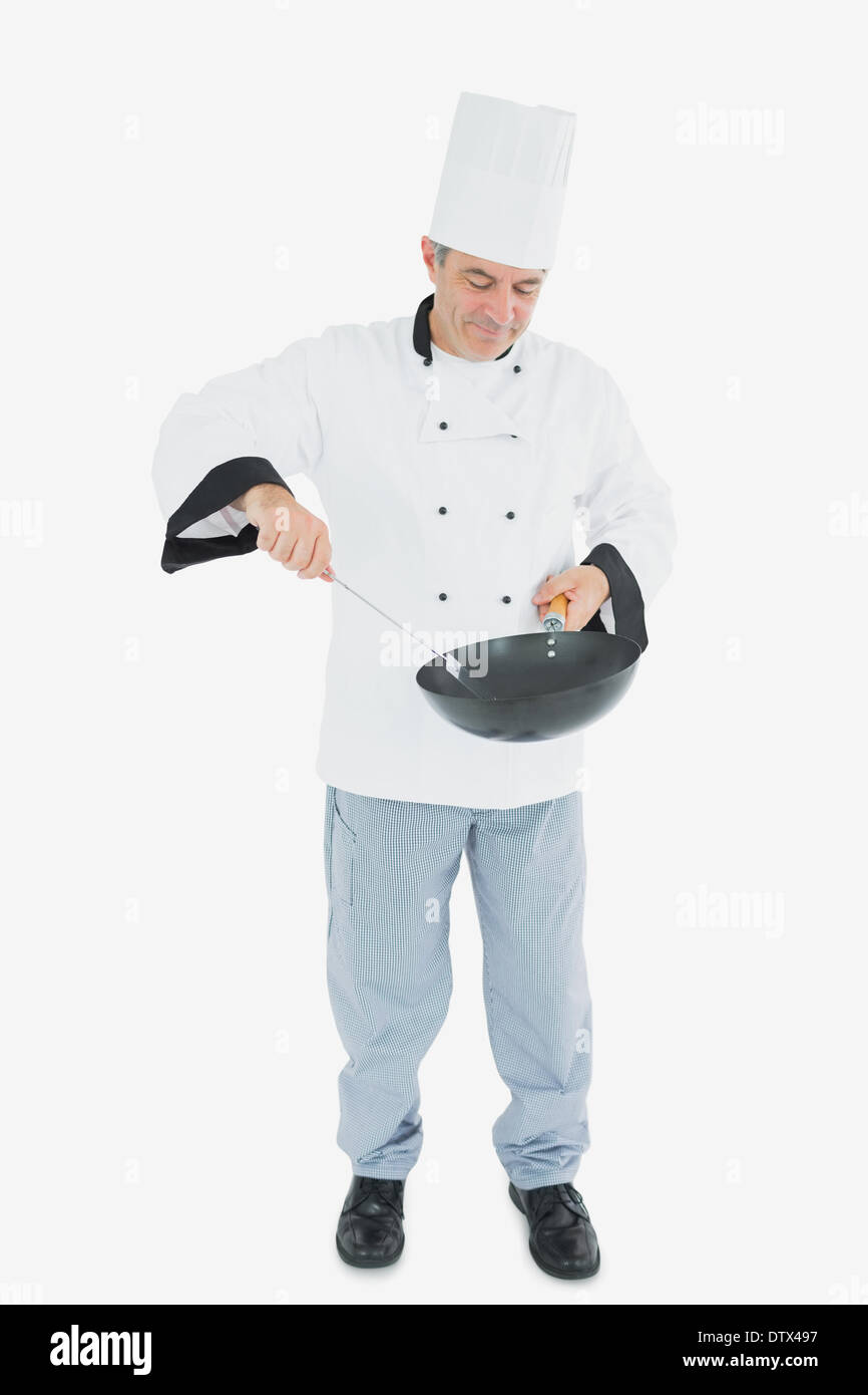 Man in chef uniform cooking food Stock Photo - Alamy