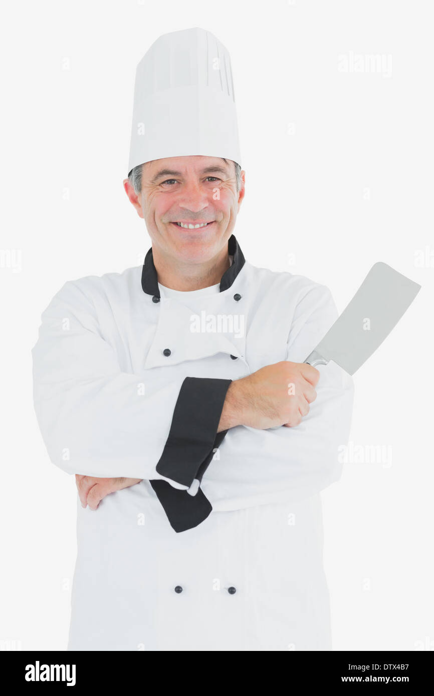 Happy chef holding meat cleaver Stock Photo - Alamy