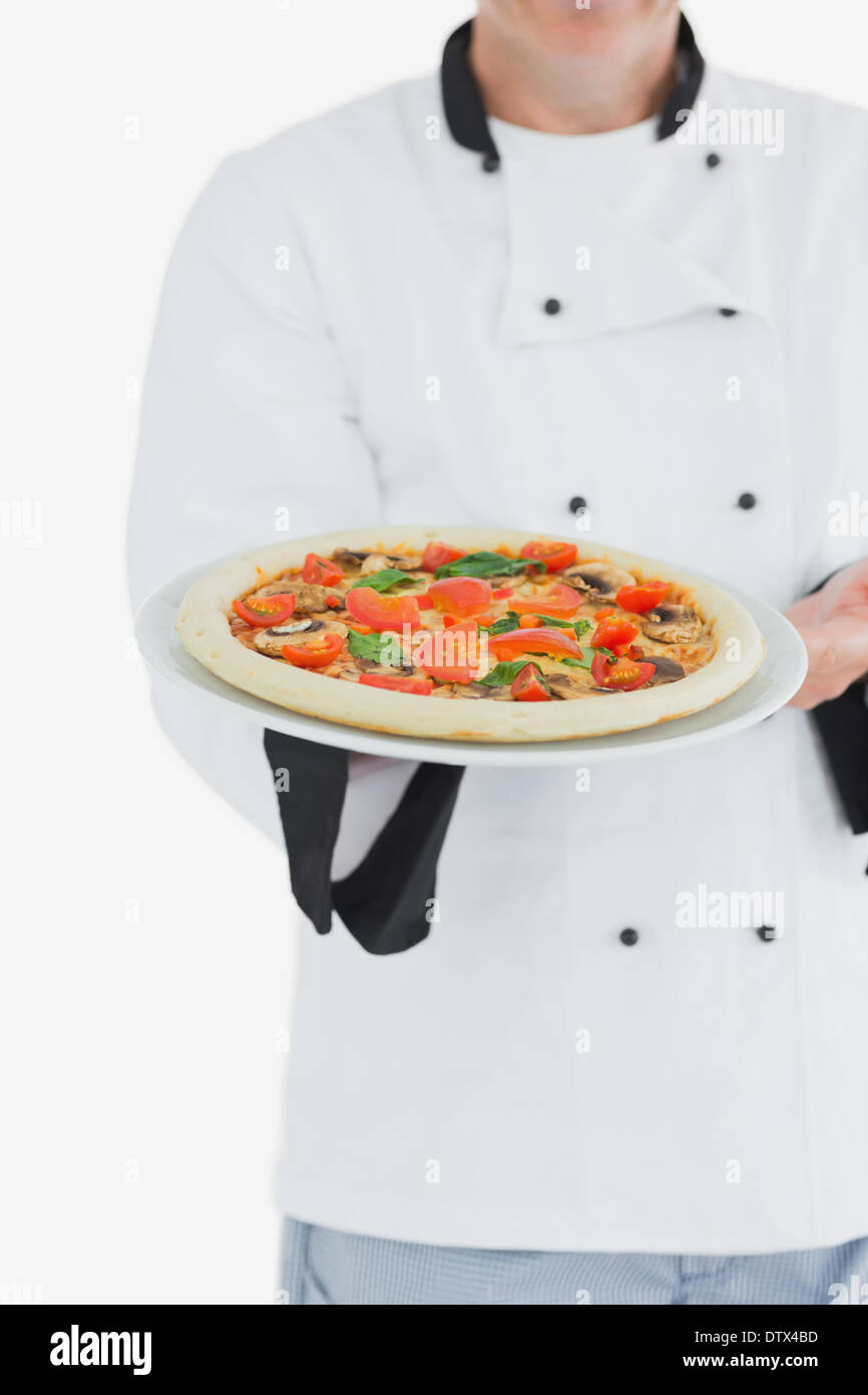Male chef offering pizza Stock Photo - Alamy