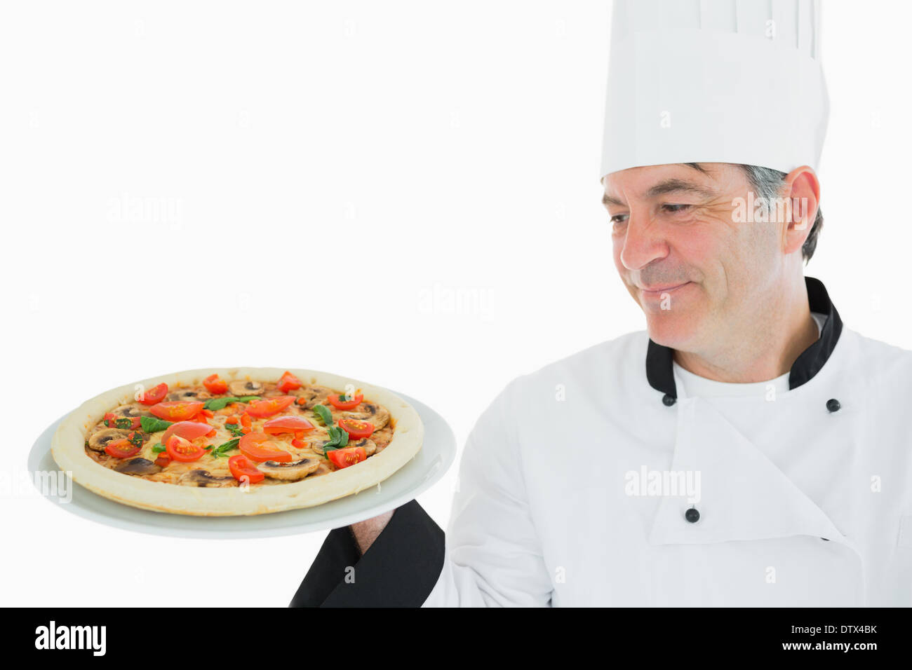 Happy chef looking at pizza Stock Photo - Alamy