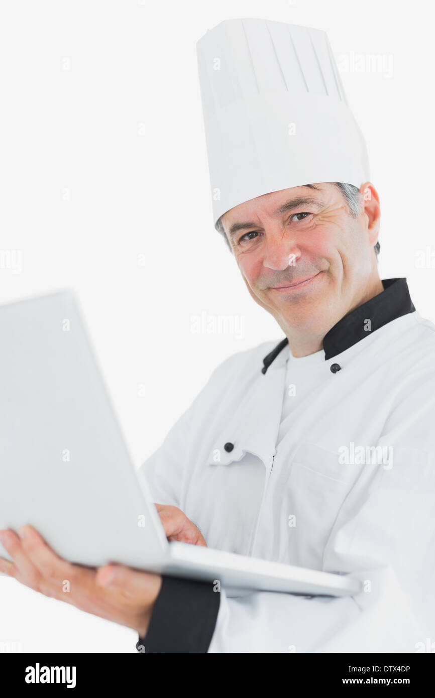 Happy male chef using laptop Stock Photo - Alamy