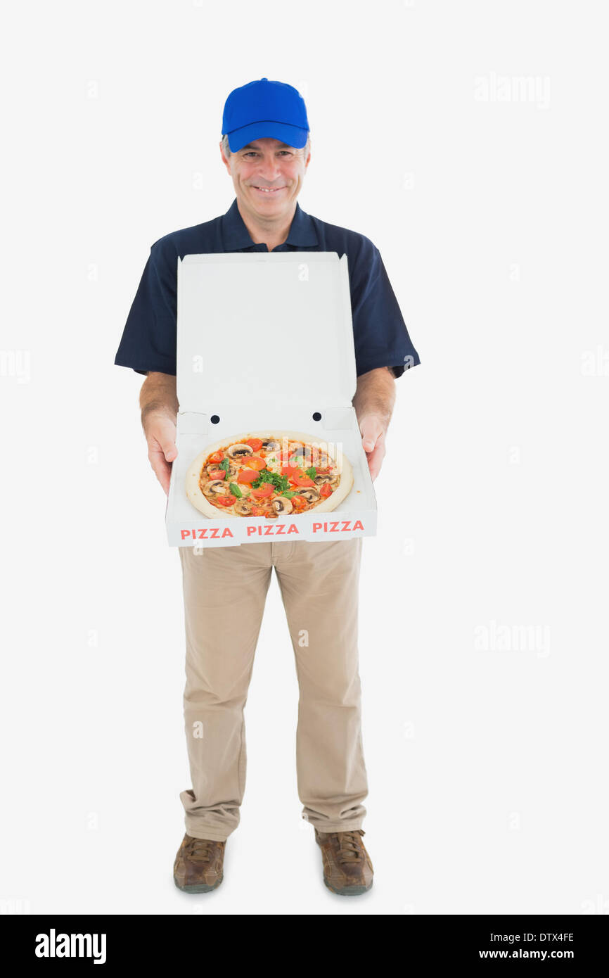 Cheerful delivery man holding pizza Stock Photo - Alamy