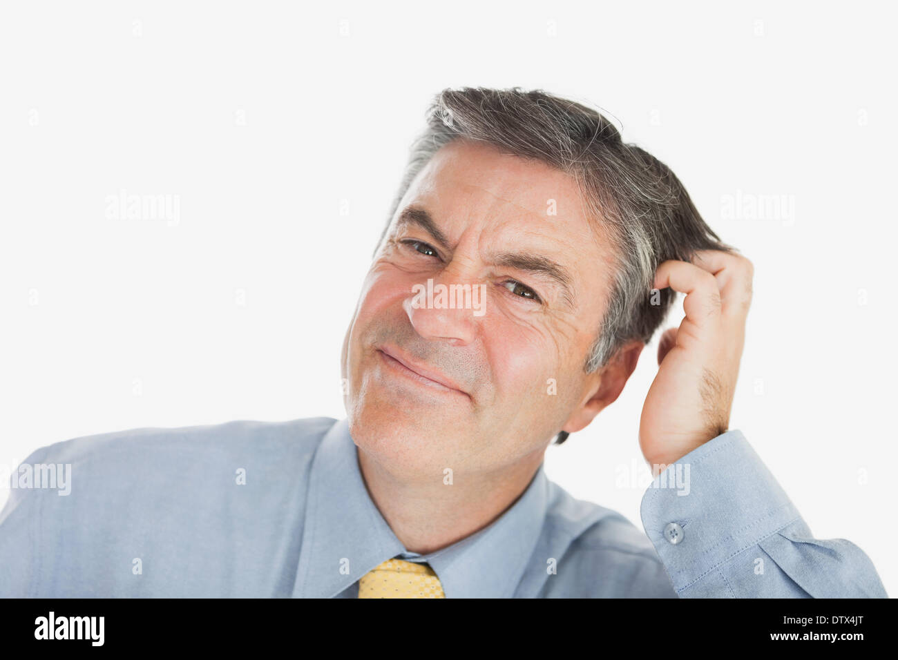 Portrait of a businessman scratching his head while thinking isolated ...