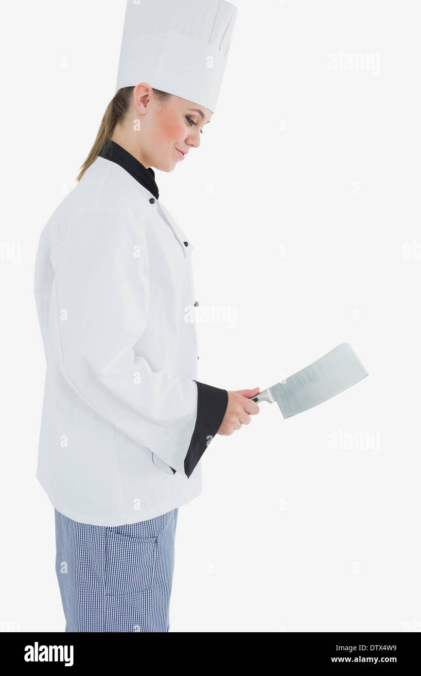 Chef holding meat cleaver as she smiles Stock Photo - Alamy