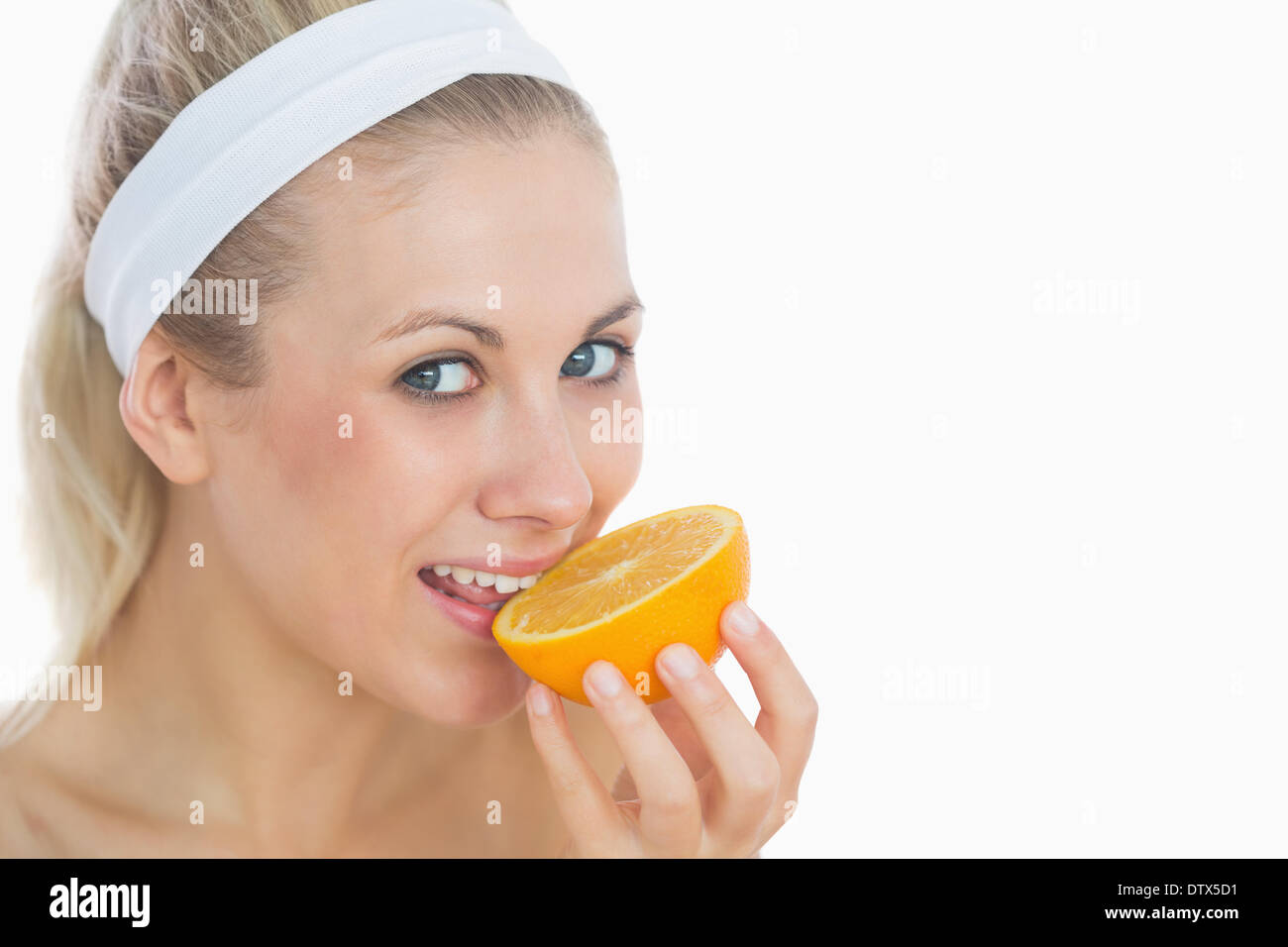 Woman biting slice of orange Stock Photo - Alamy