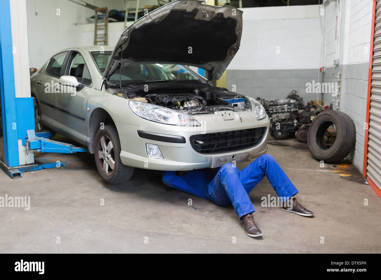 Male mechanic working under car Stock Photo - Alamy