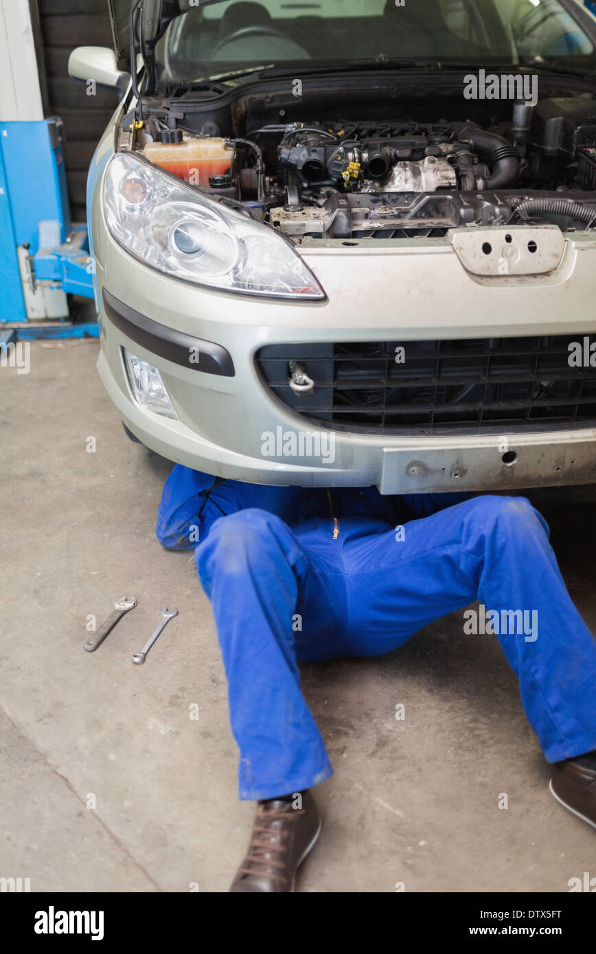Auto mechanic working under car Stock Photo - Alamy