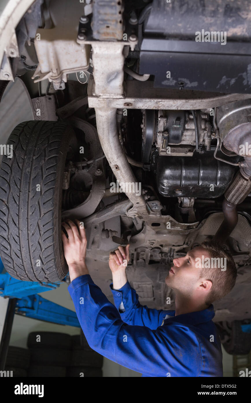 Mechanic working under car Stock Photo - Alamy