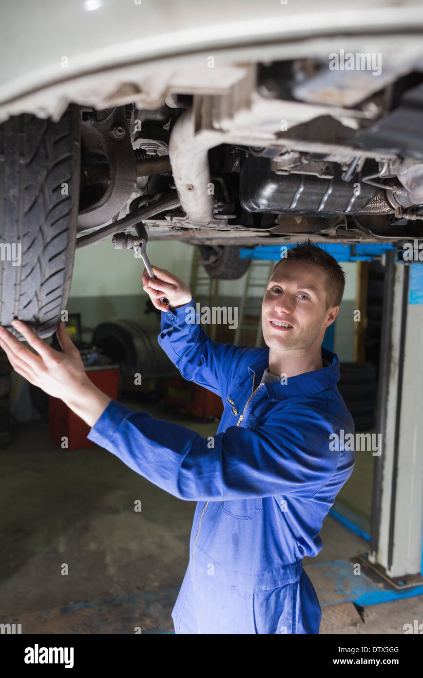 Mechanic standing repairing below hi-res stock photography and images ...