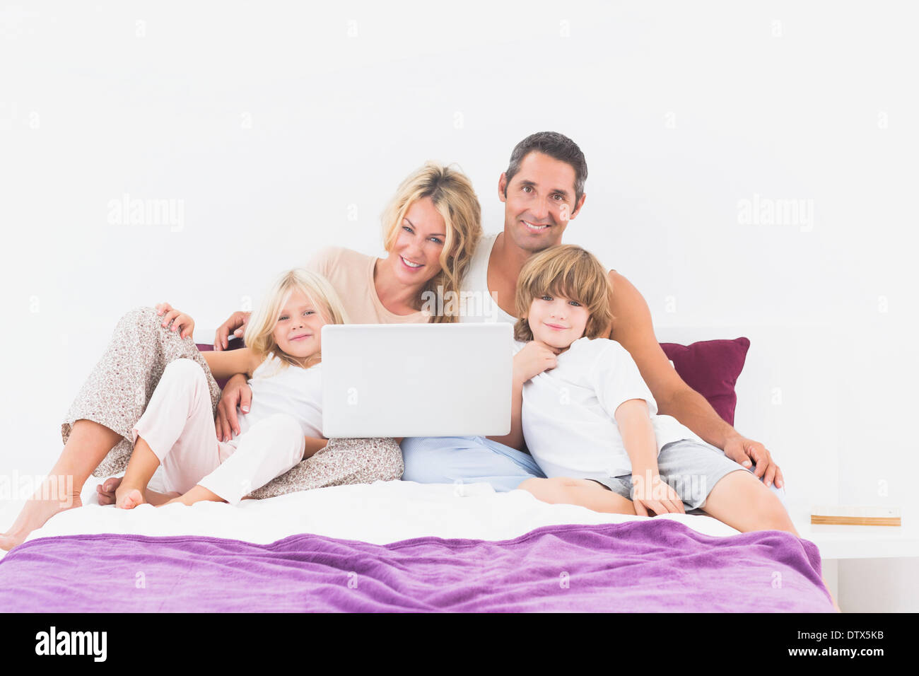 Cute family using laptop sitting hi-res stock photography and images ...