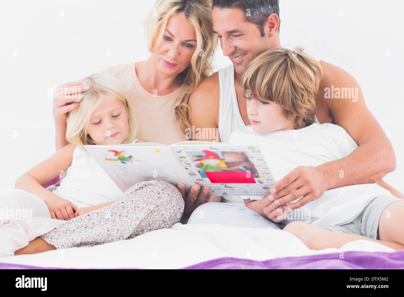 Family reading a story together Stock Photo - Alamy
