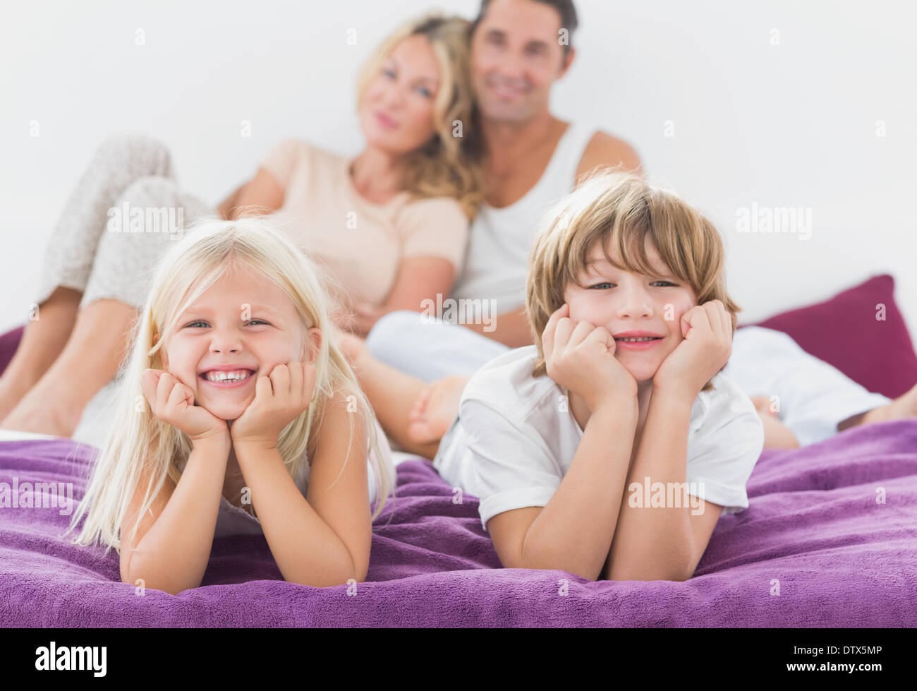 Brother and sister lying on a bed Stock Photo - Alamy